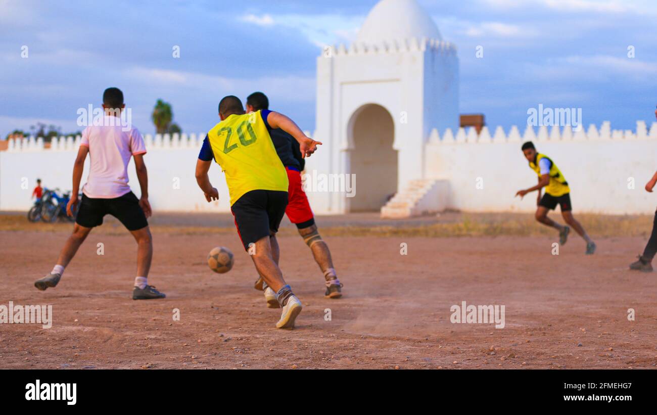 Marrakech, Morocco - 25 APRIL 2021 : Men playing football on a dusty ...