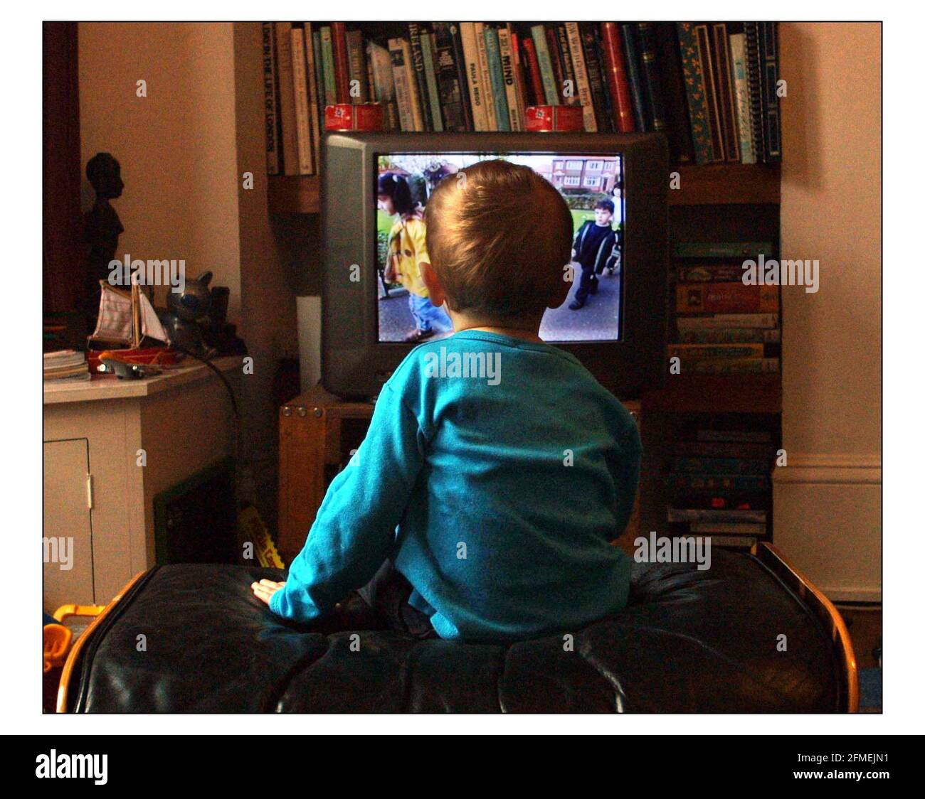 Oliver Bennett watching Tv with his son Bruno.pic David Sandison 30/10 ...
