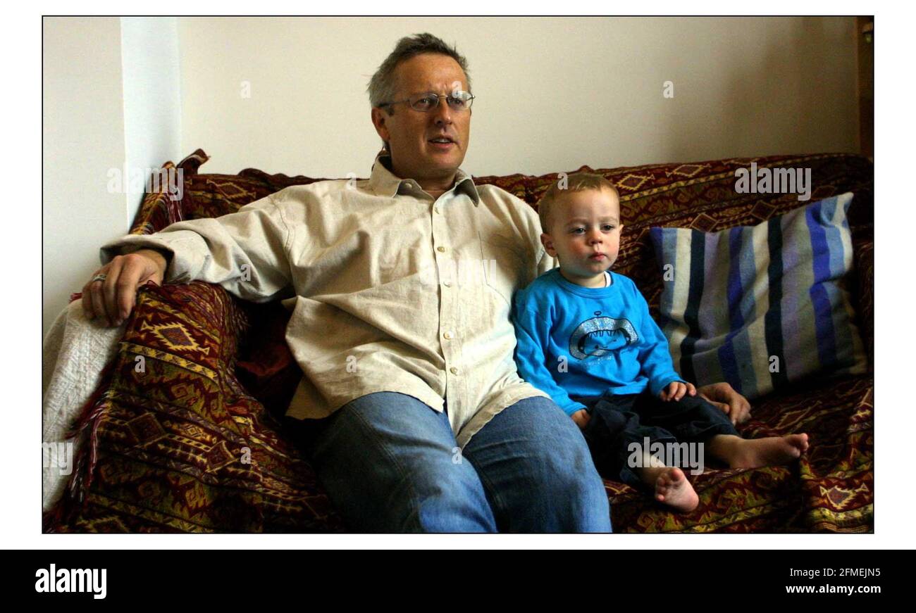 Oliver Bennett watching Tv with his son Bruno.pic David Sandison 30/10 ...