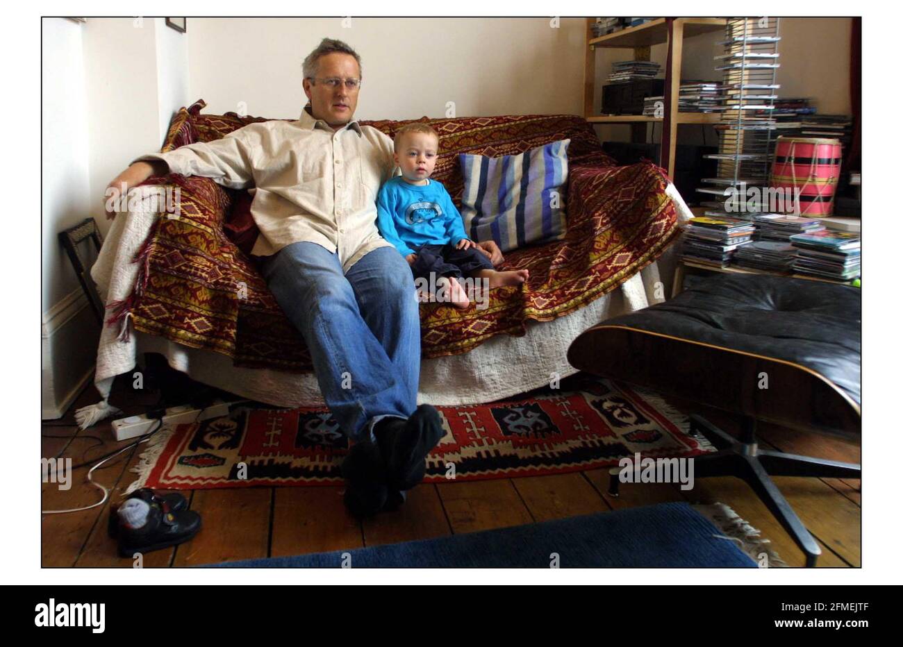 Oliver Bennett watching Tv with his son Bruno.pic David Sandison 30/10 ...