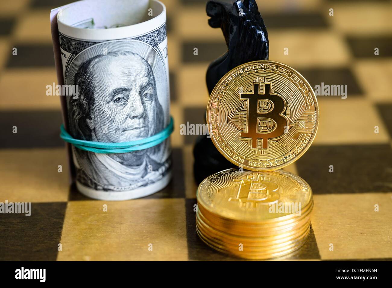 Dollar bills and bitcoin stack on chessboard. US cash, gold bit coins ...