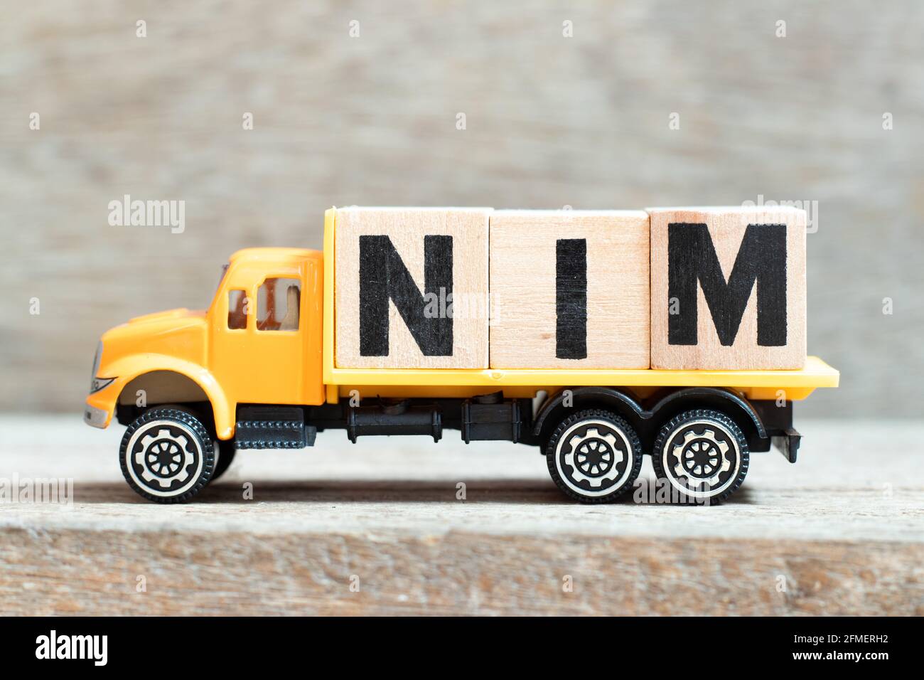 Toy truck hold alphabet letter block in word NIM (Abbreviation of Net ...