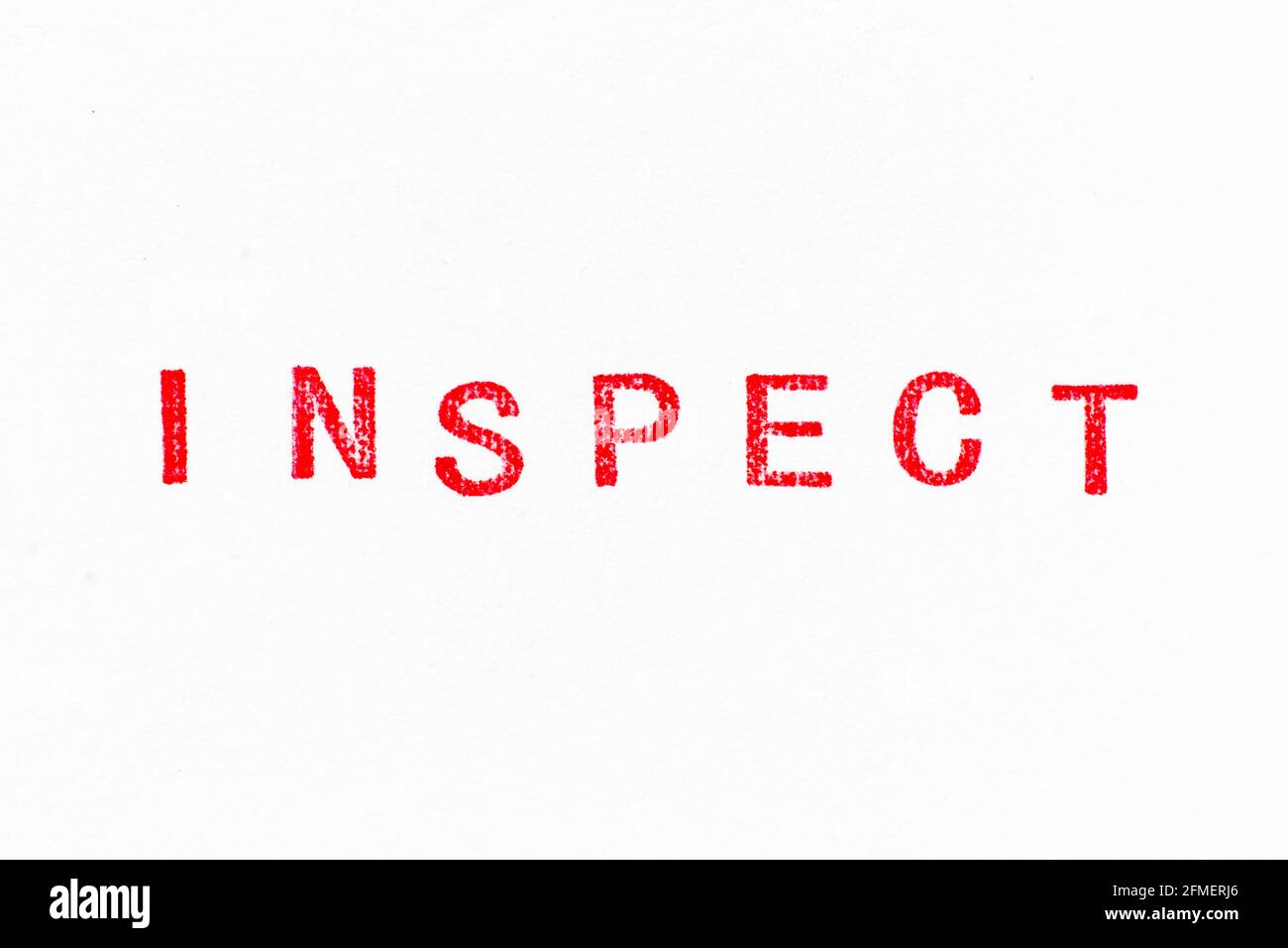 Red color ink rubber stamp in word inspect on white paper background ...
