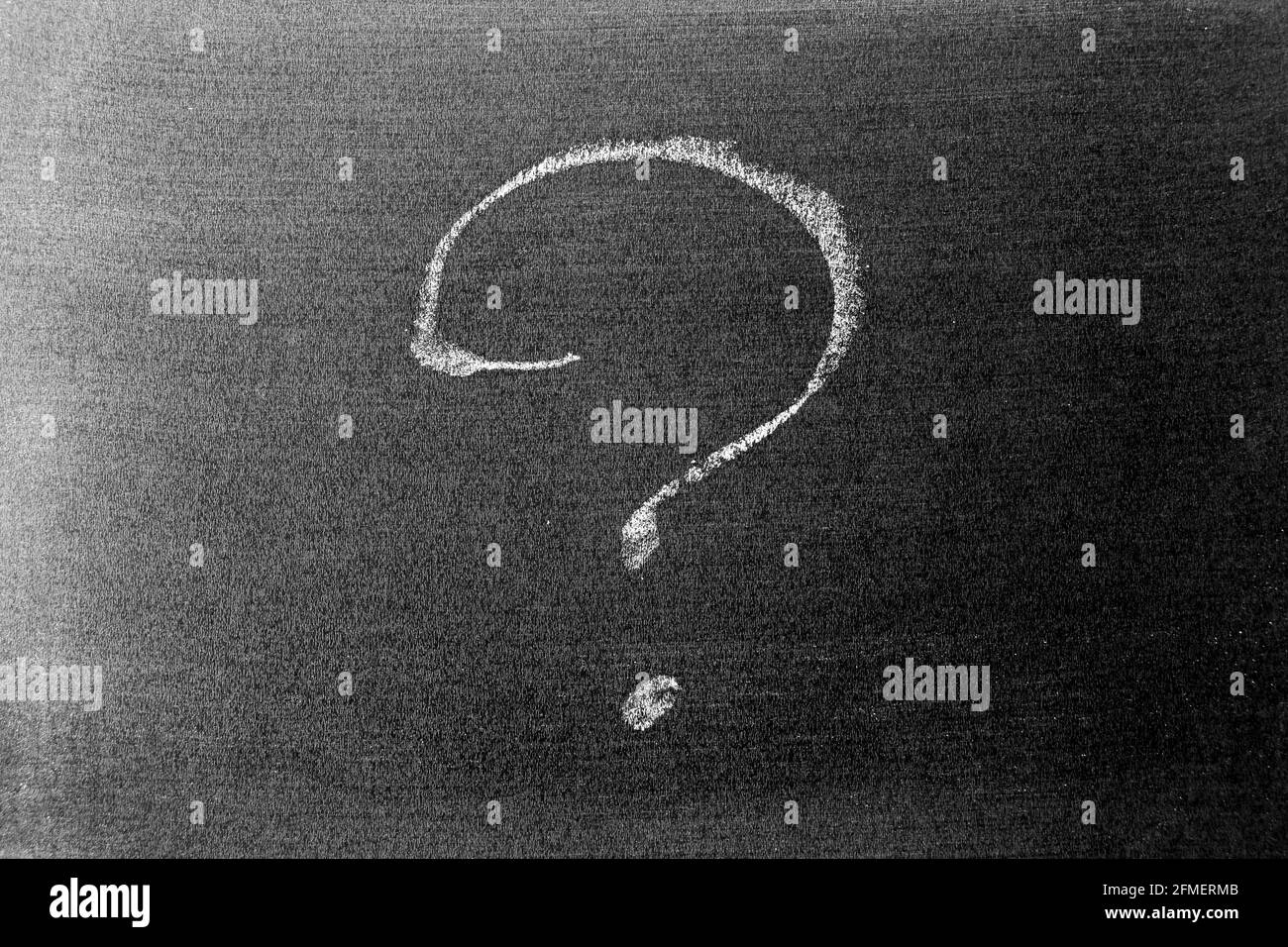 White color chalk hand drawing in question mark shape on blackboard or ...