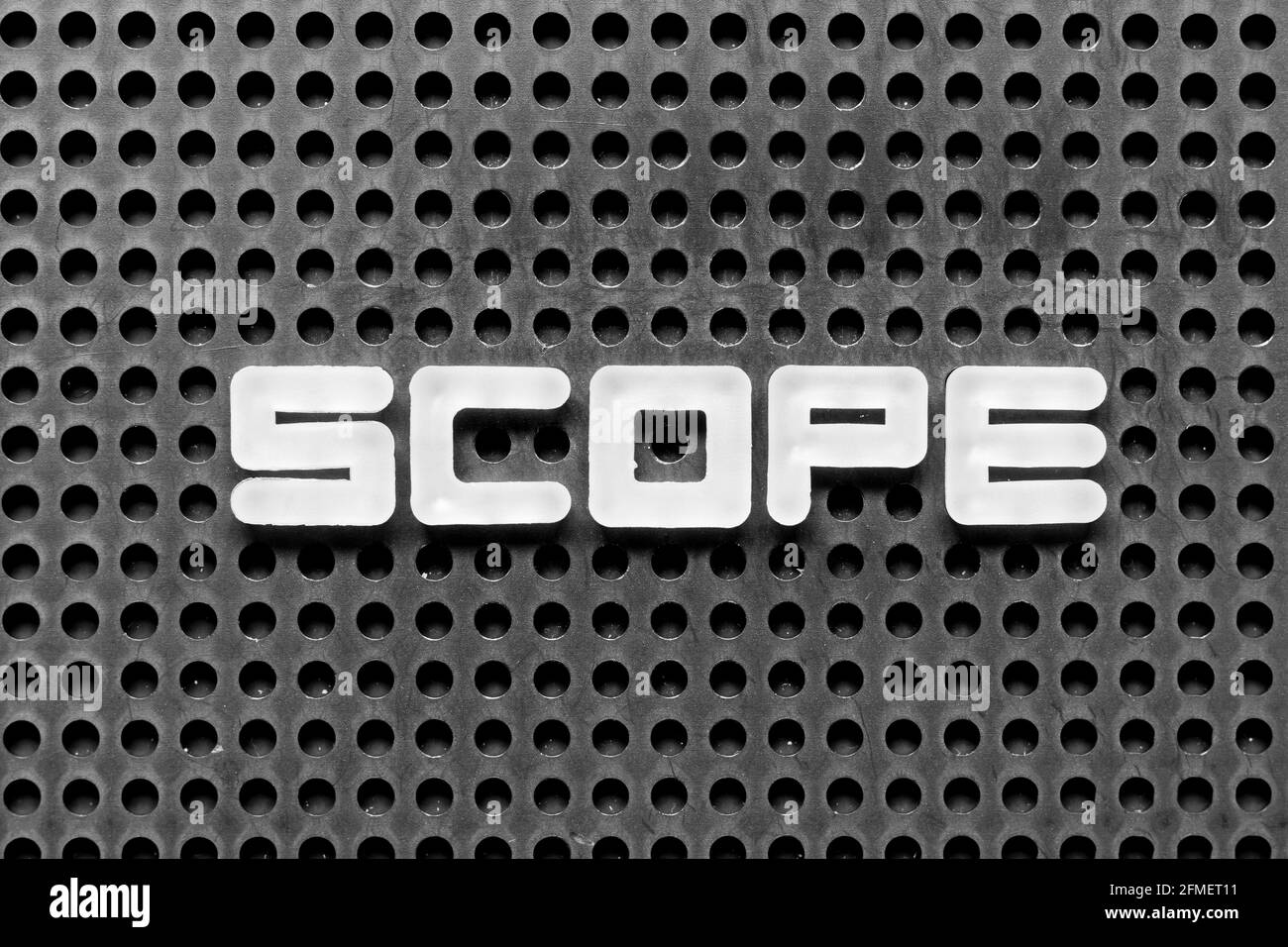 White alphabet letter in word scope on black pegboard background Stock ...