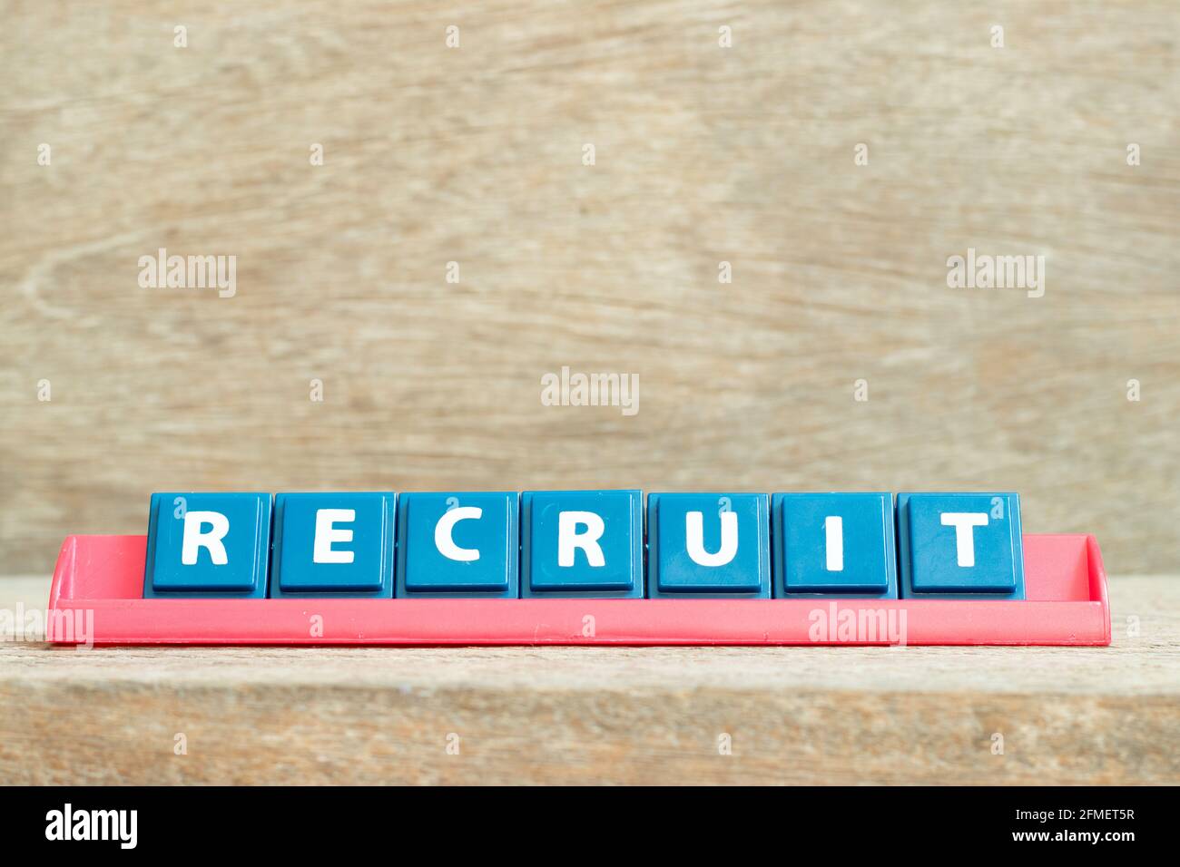 Tile alphabet letter with word recruit in red color rack on wood ...