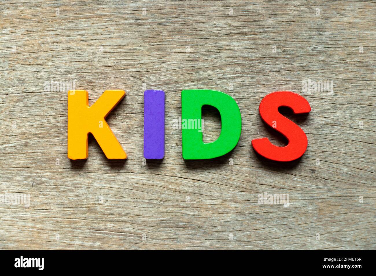 Color alphabet letter in word kids on wood background Stock Photo - Alamy