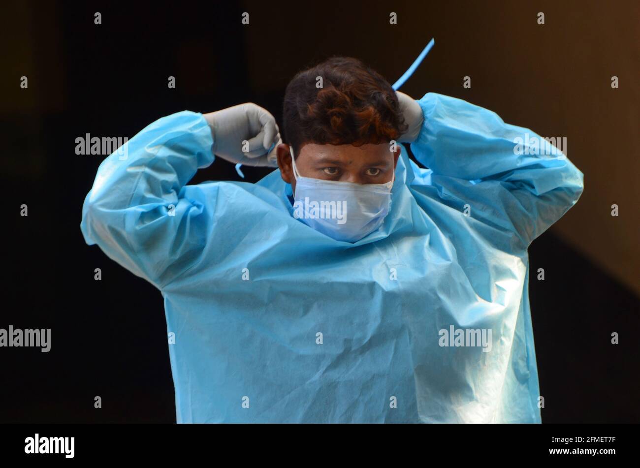 A health worker wearing Personal Protective Equiption (PPE) in a ...