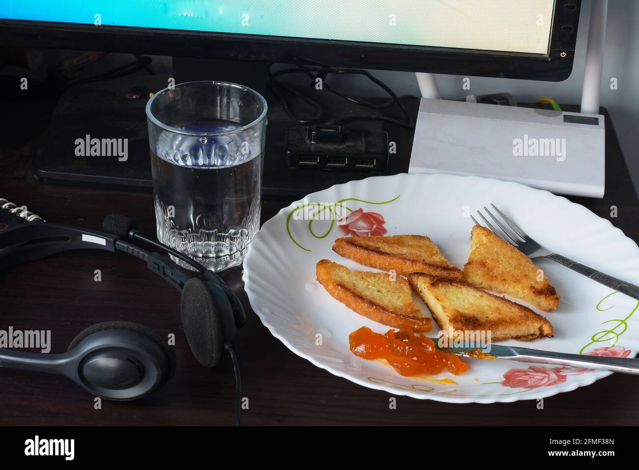 Crispy and golden toast with mango jam, and a glass of water Stock ...