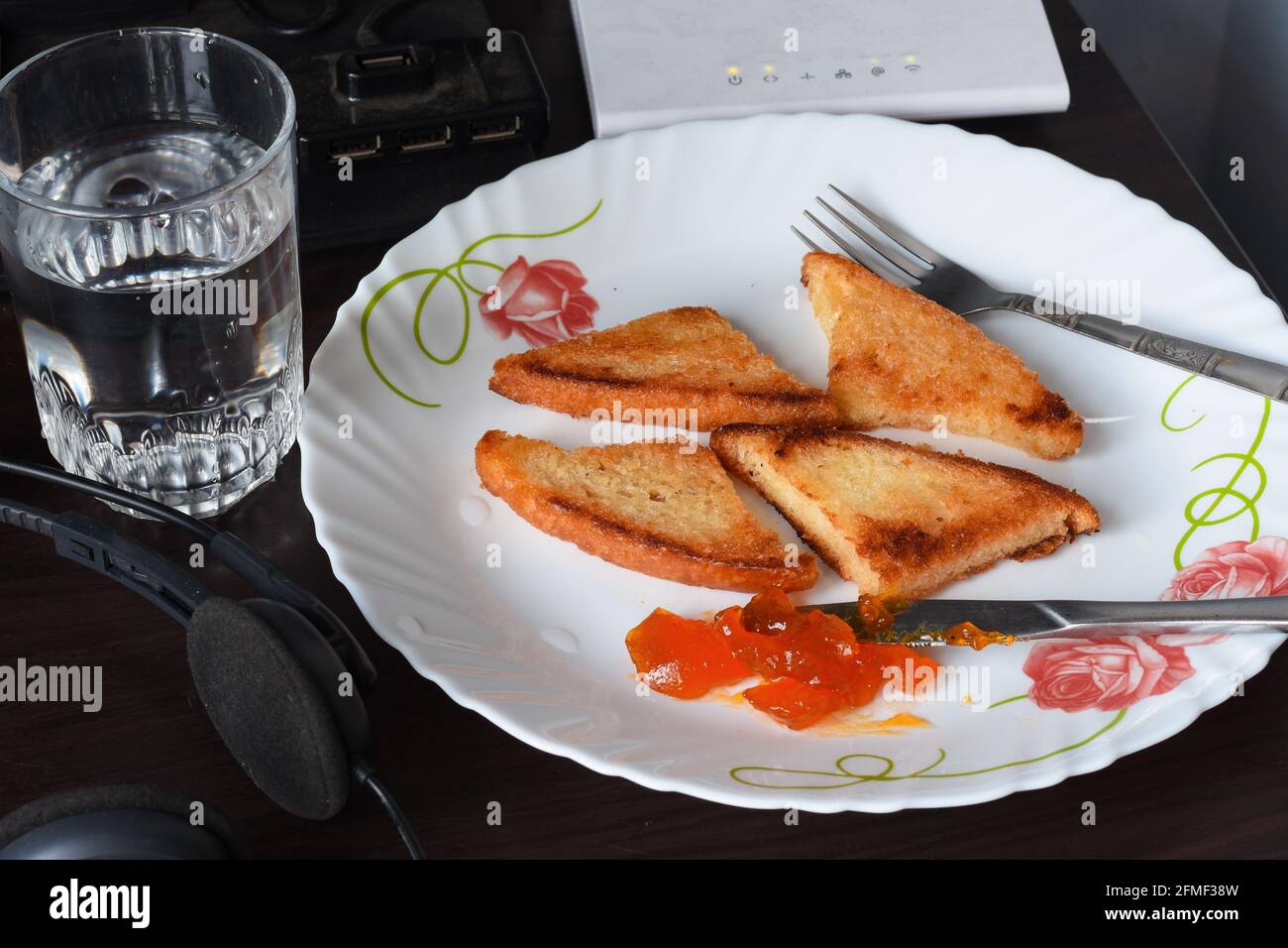 Crispy and golden toast with mango jam, and a glass of water Stock ...