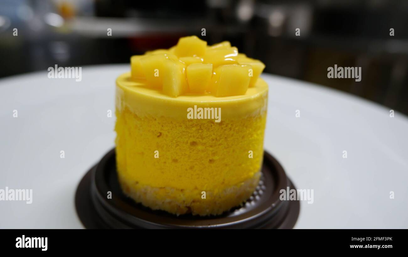 A mango mousse on white plate Stock Photo - Alamy