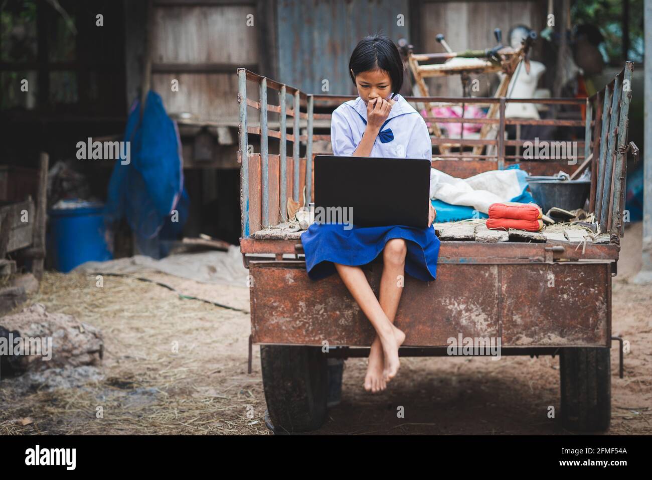 Asian uniform student girl using computer laptop During the lock-down ...