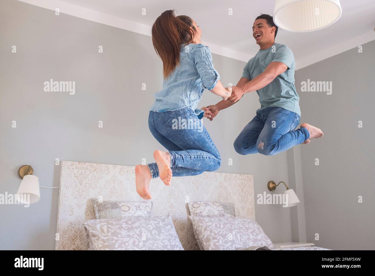 Young couple love life together at home and jump in the air in the ...