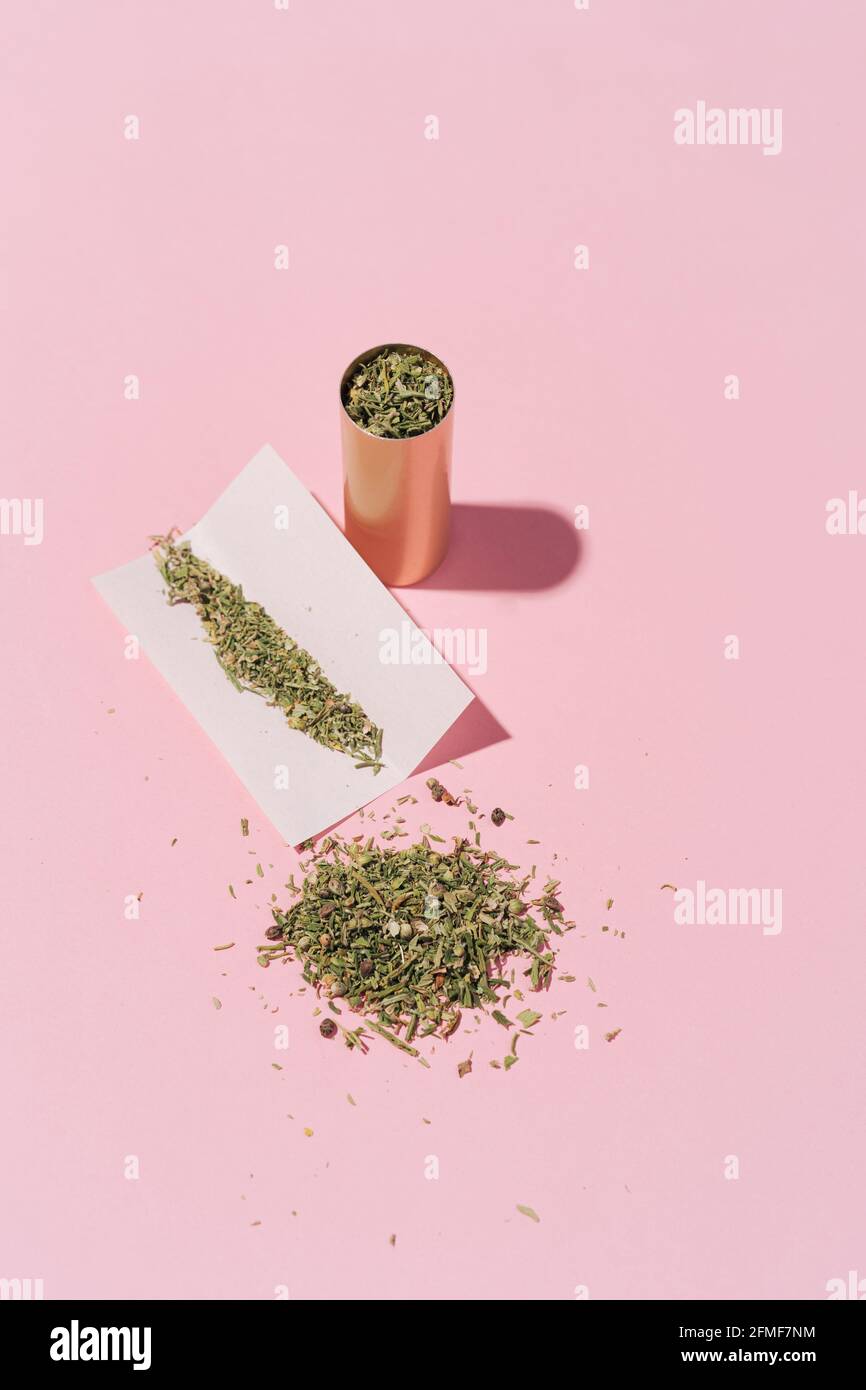 hipster photo of can, paper and dry Cannabis leafs on pink background ...
