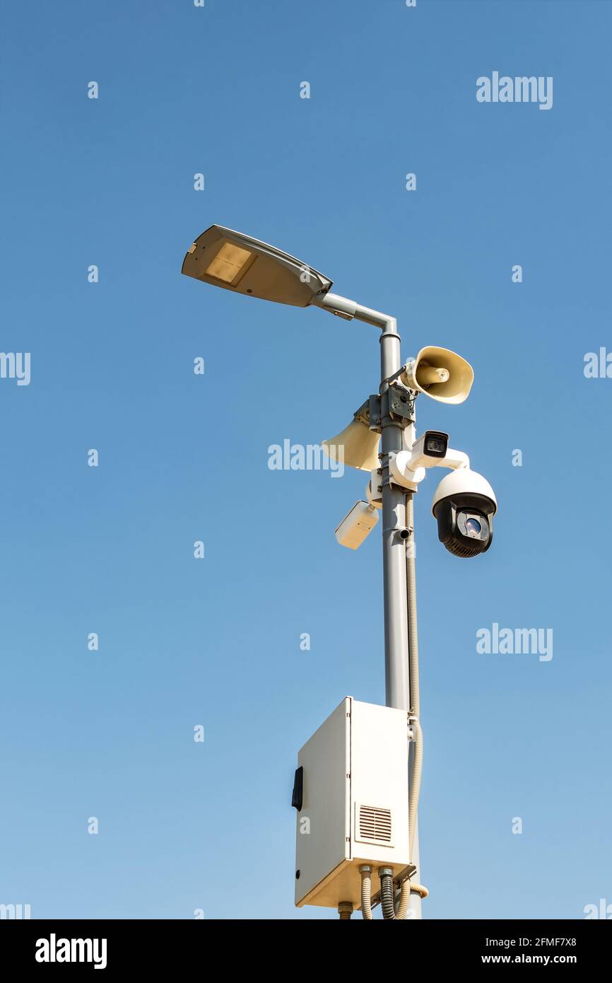 A cluster of security cameras on a lamppost, in a public Park on the ...