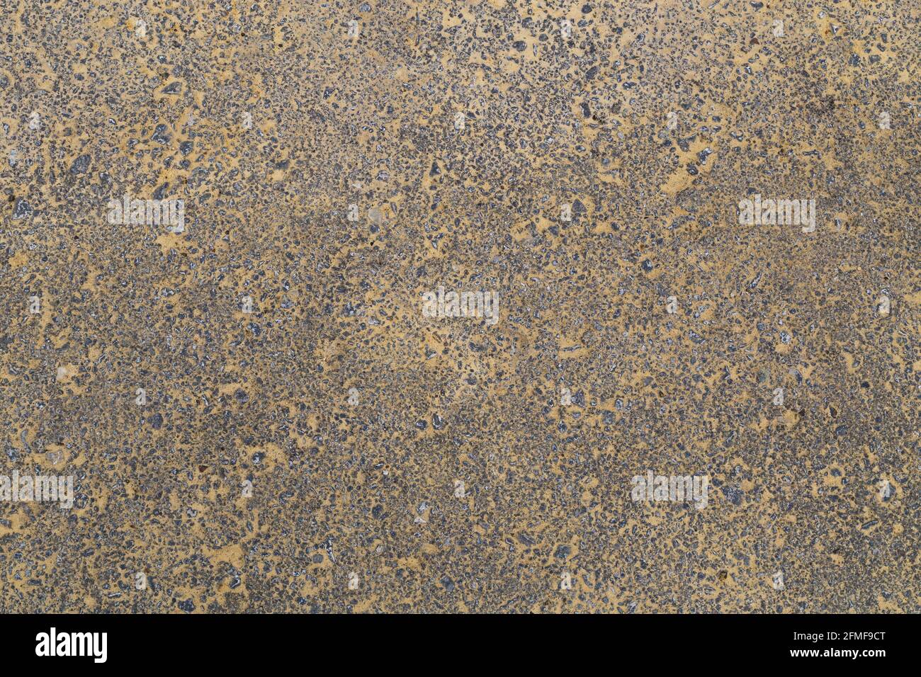 yellow sand covered asphalt texture and background, directly above view ...