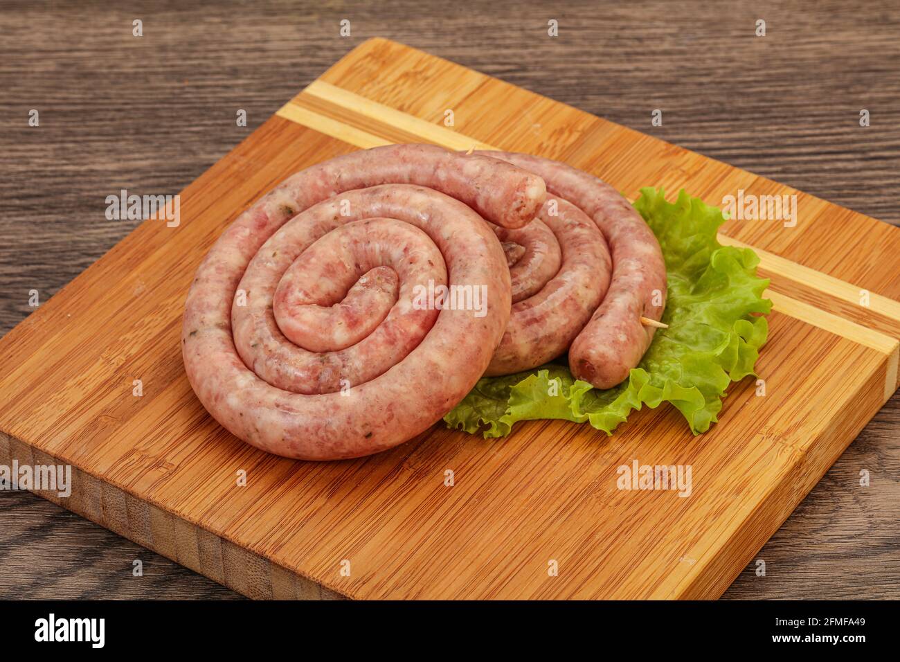 Raw pork sausage ring for grill Stock Photo - Alamy