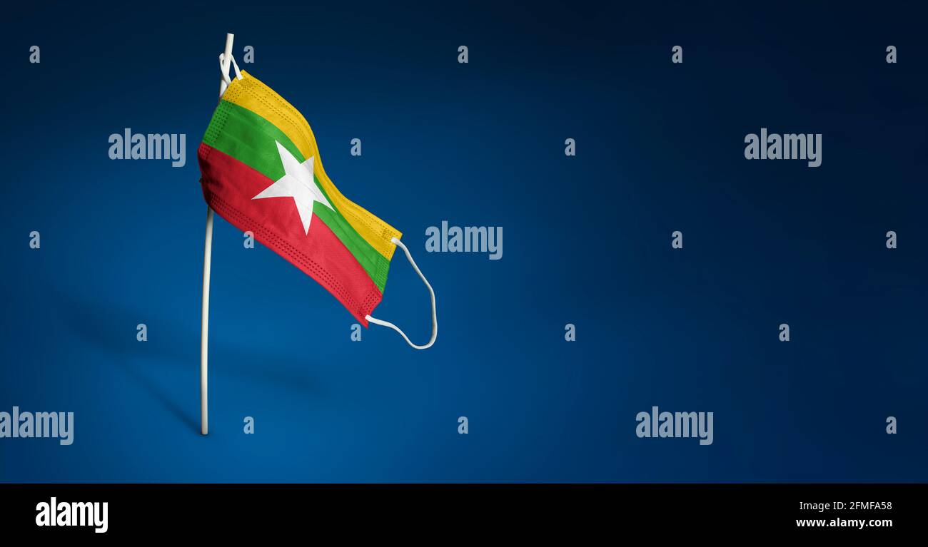 Myanmar mask on dark blue background. Waving flag of Myanmar painted on ...