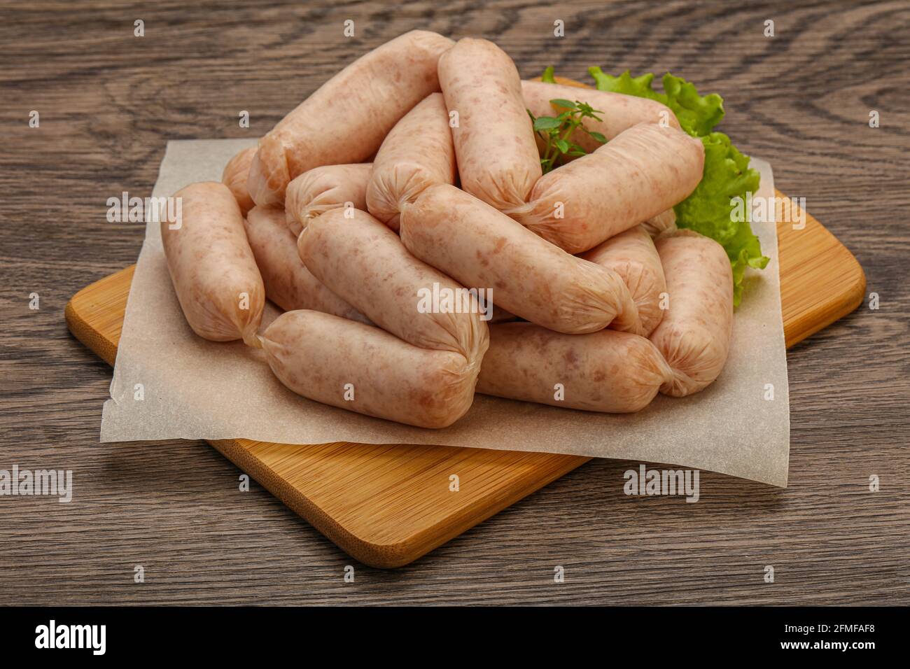 Raw natural chicken baby sausages for roast Stock Photo - Alamy