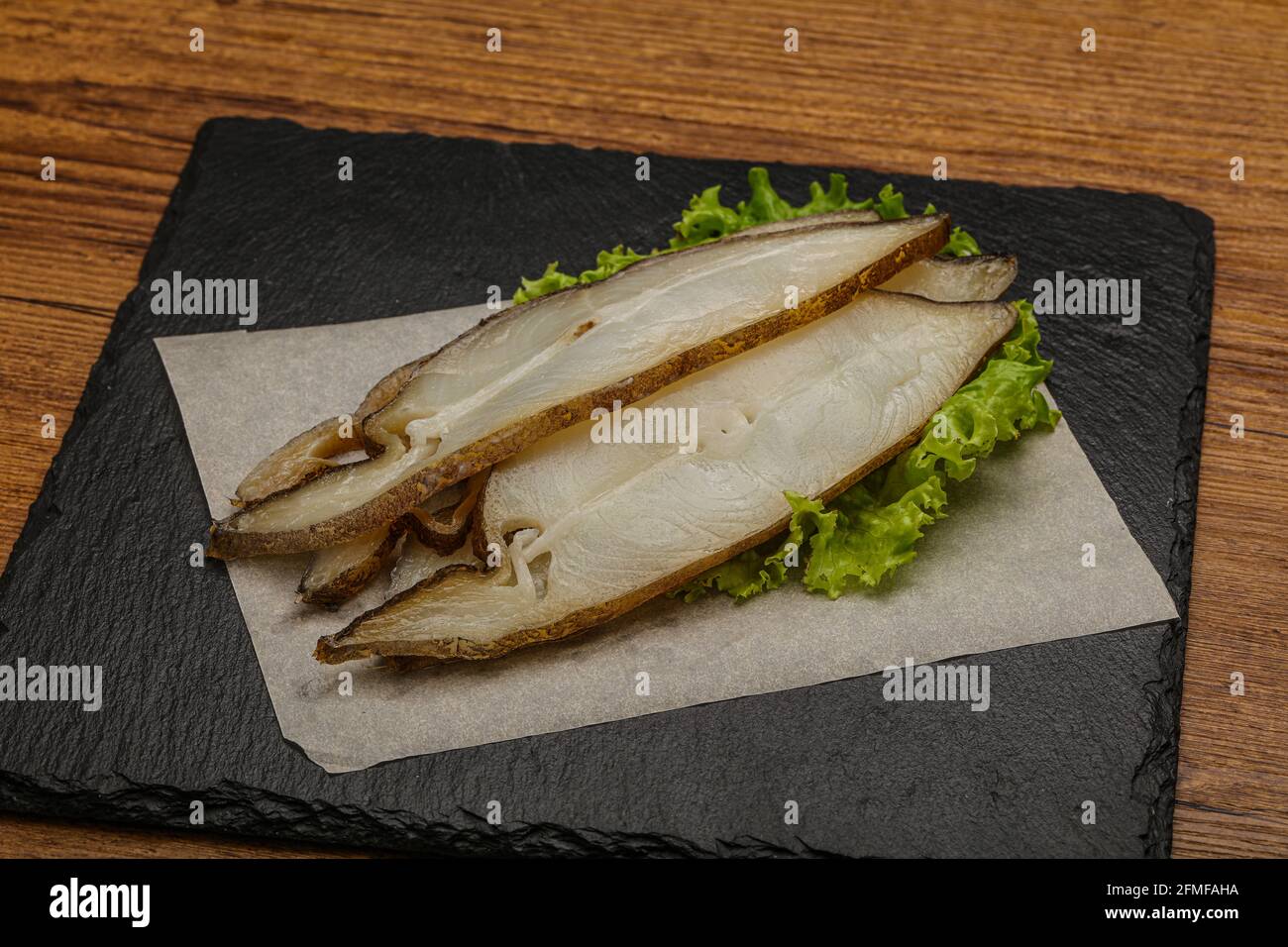 Delicous smoked halibut fish slices snack Stock Photo - Alamy