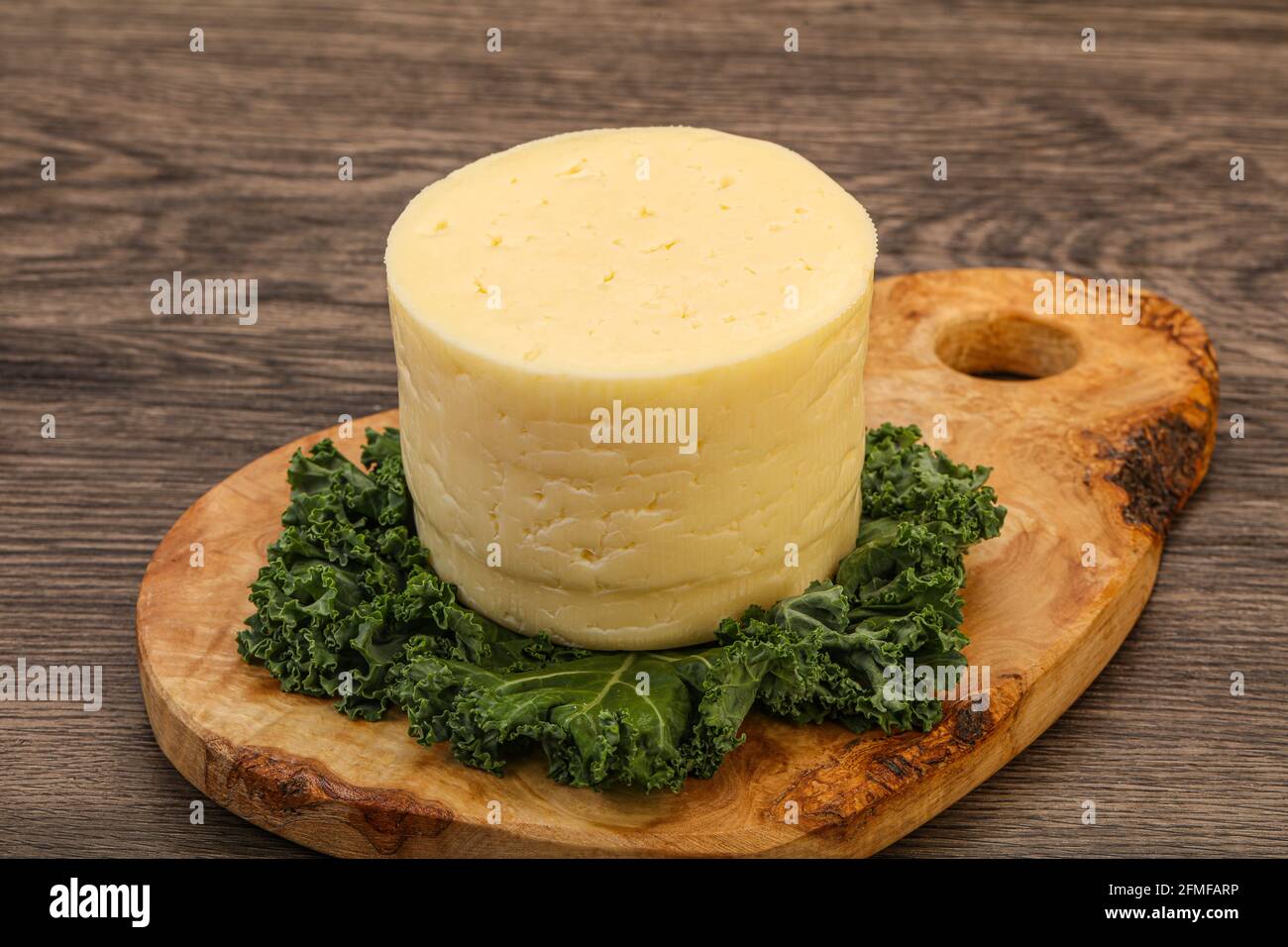 Yellow round dairy soft cheese piece Stock Photo - Alamy