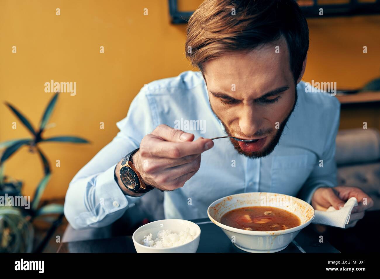 man eating lunch in a restaurant hot broth food break at work Stock ...