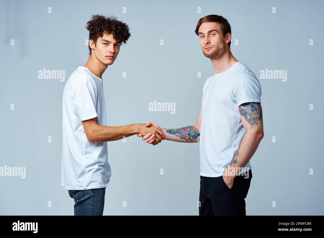 two men friendship shaking hands isolated background Stock Photo - Alamy