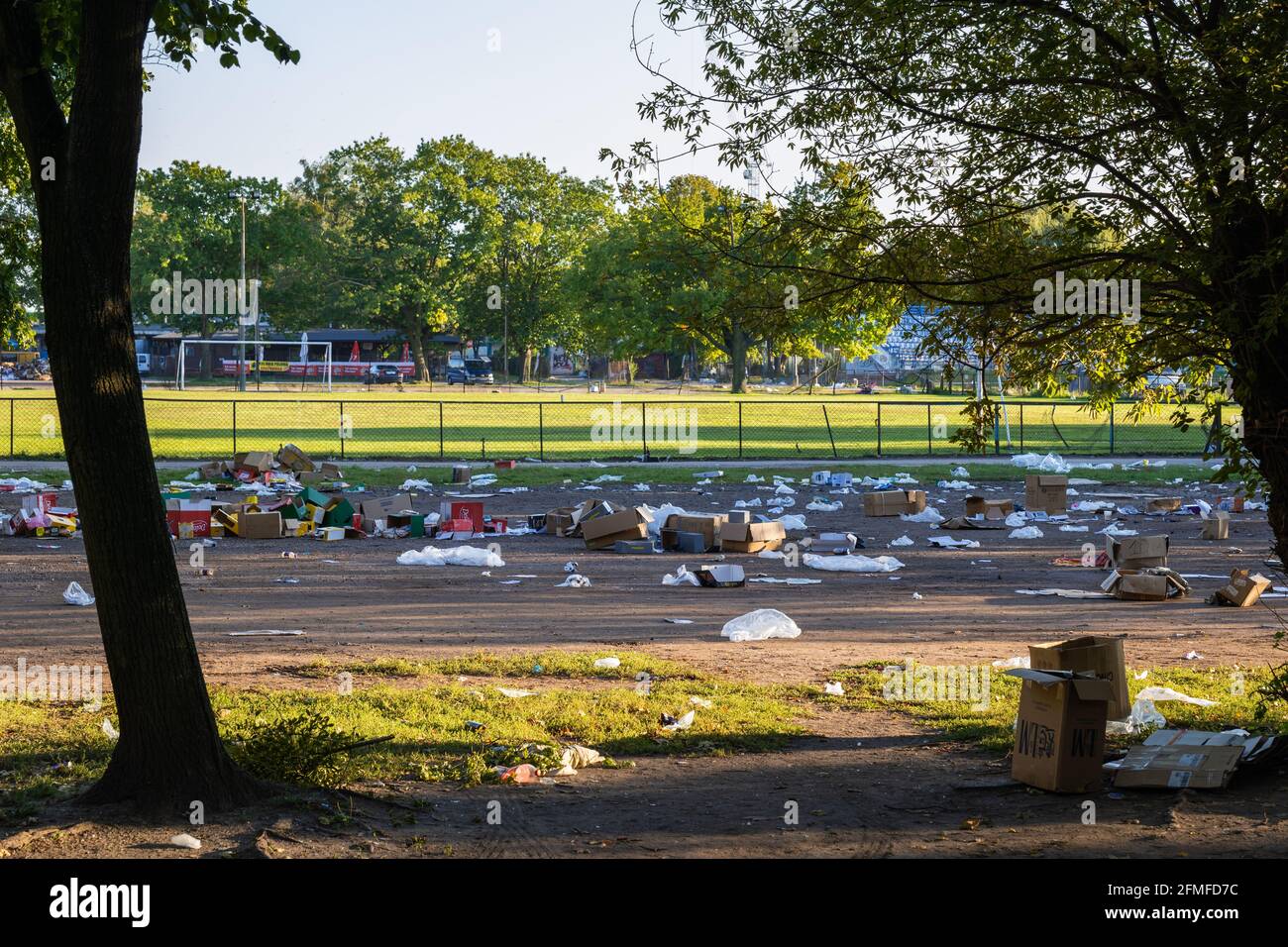 Piles of garbage, littered outdoor market place, plastic, paper trash ...