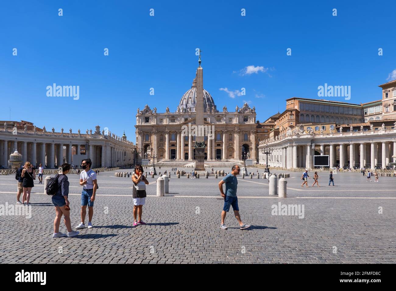Vatican City, people on St. Peter Square with Saint Peter Basilica ...