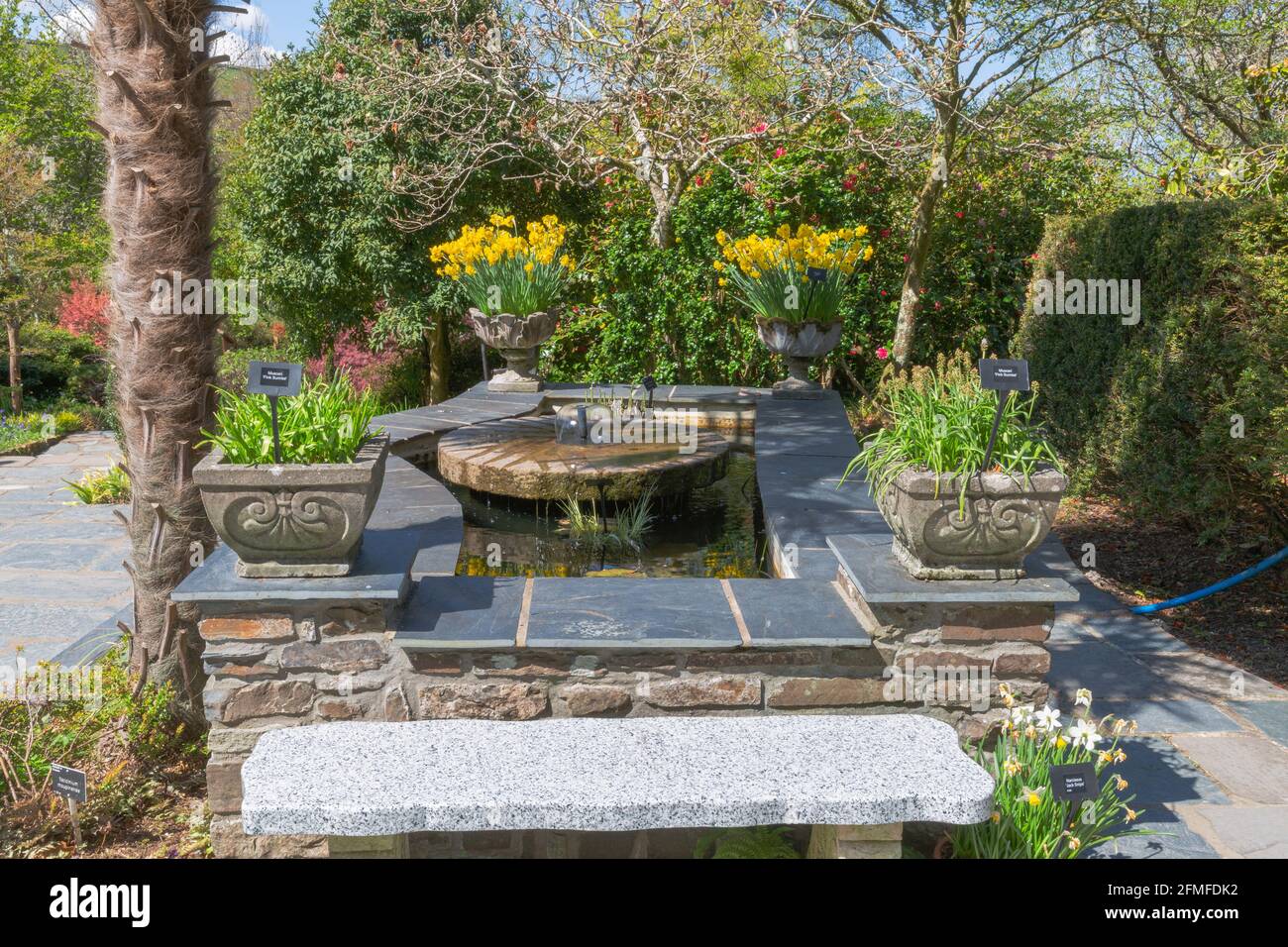 Stone walled water feature with circular stone centre piece and small ...