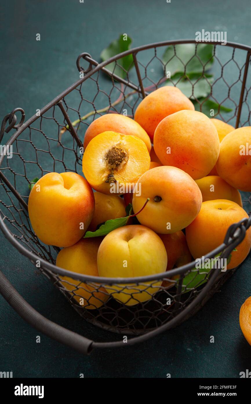 Apricots in basket dark background hi-res stock photography and images ...