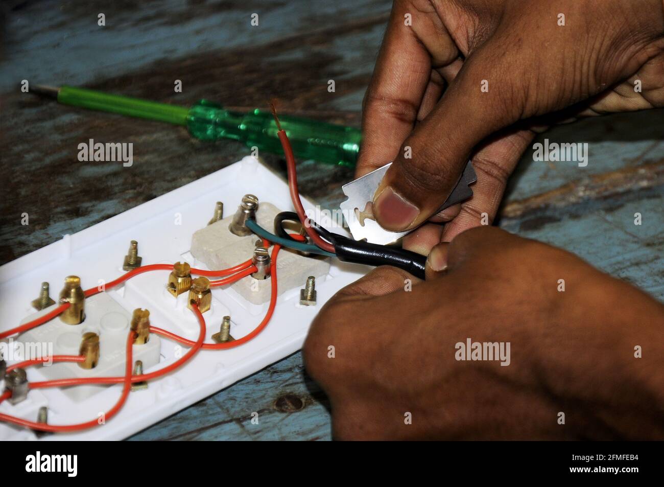 Electrician working safely on switches and sockets of a residential ...
