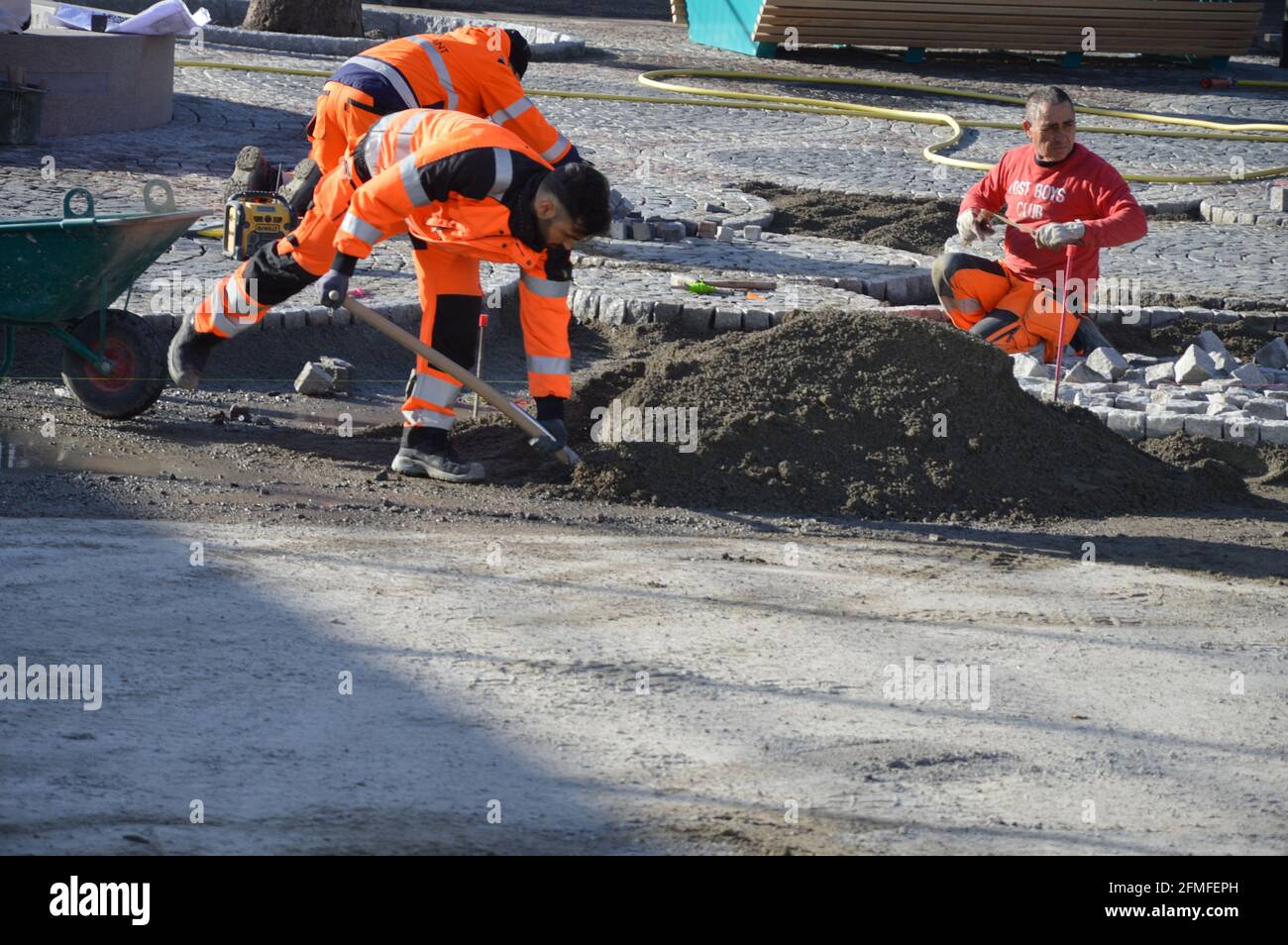 Mason workers making pavement construction works in central Kärrtorp ...