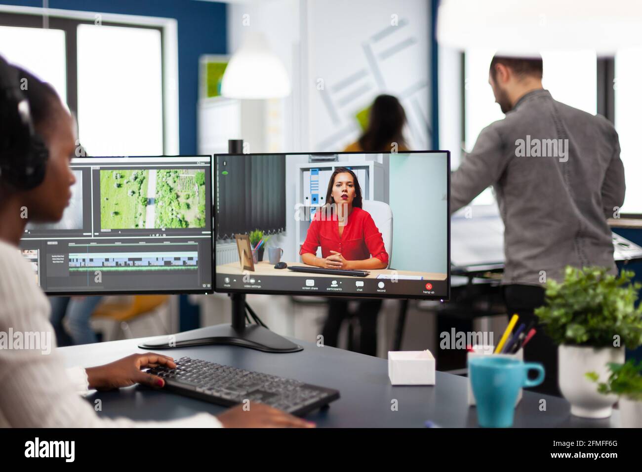 African woman editor with headset talking during online conference with ...