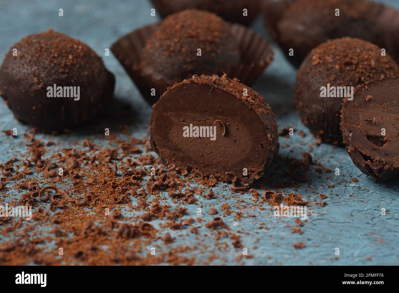 Chocolate petit fours on a table. Chocolate petit four sweets with ...