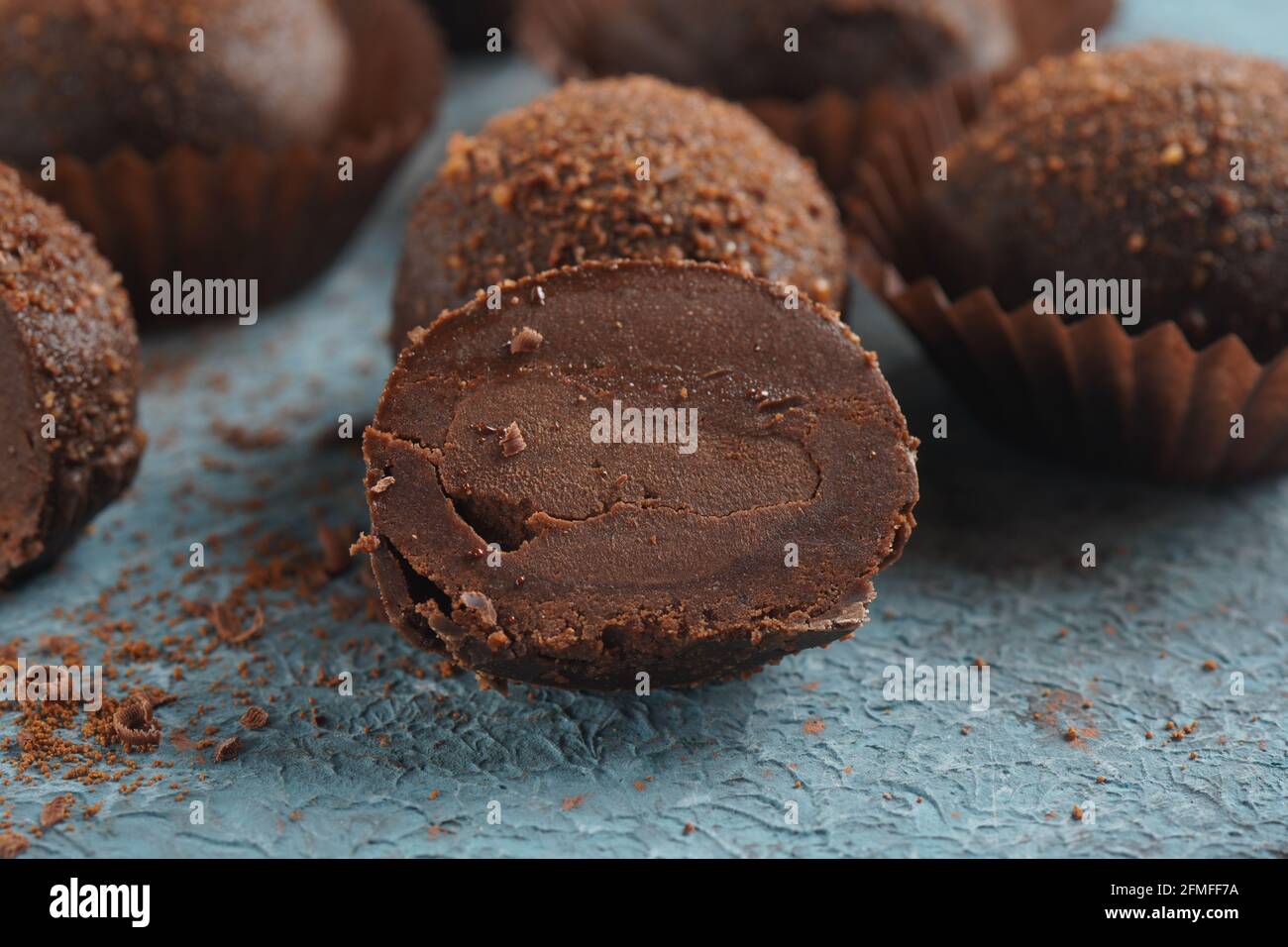 Chocolate petit fours on a table. Chocolate petit four sweets with ...