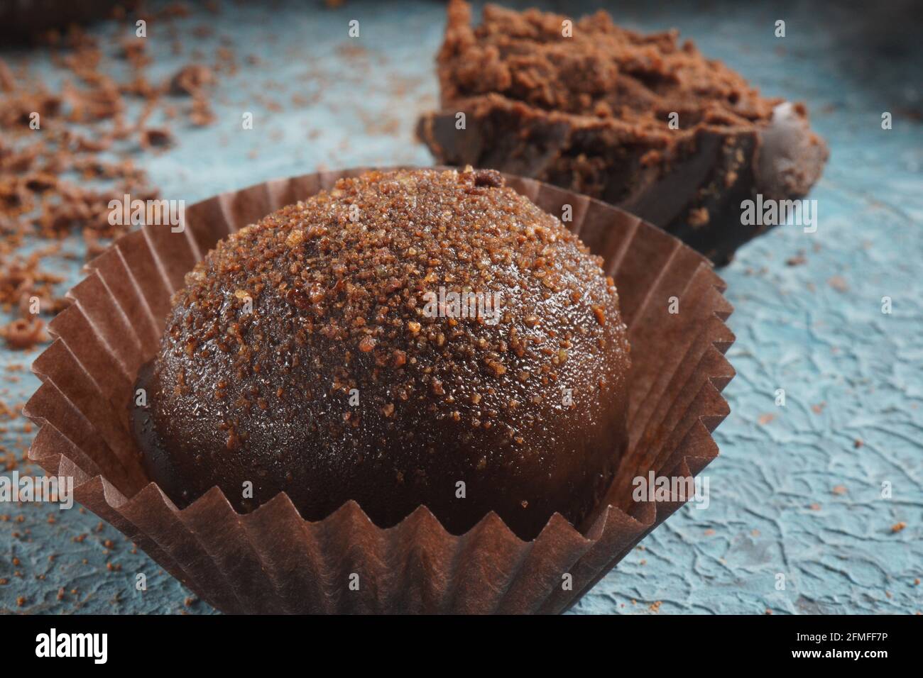 Chocolate petit fours on a table. Chocolate petit four sweets with ...