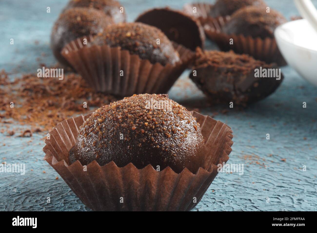 Chocolate petit fours on a table. Chocolate petit four sweets with ...