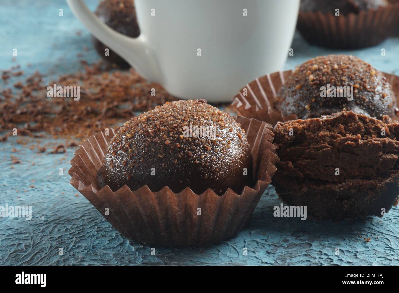 Chocolate petit fours on a table. Chocolate petit four sweets with ...