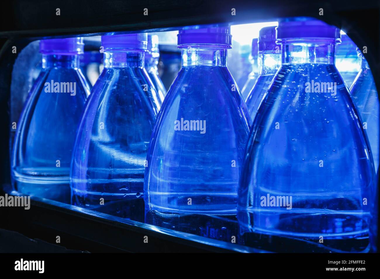 Bottles of drinking water in the water production plant Stock Photo - Alamy