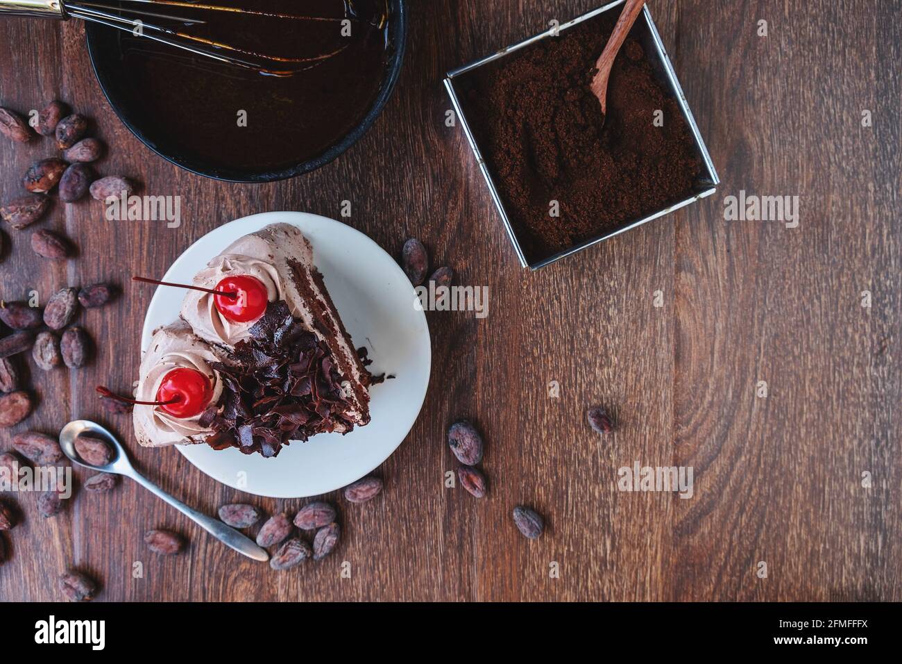 Slice of chocolate cheesecake on plate, above view over a rustic wood ...