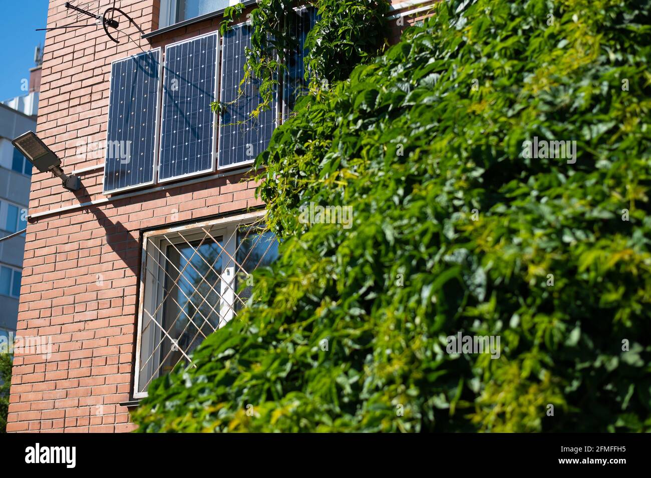 Close-up of solar panels on a red brick wall. Alternative energy source ...
