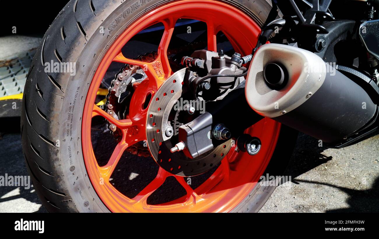 Motorcycle back wheel with a bright red rim Stock Photo - Alamy