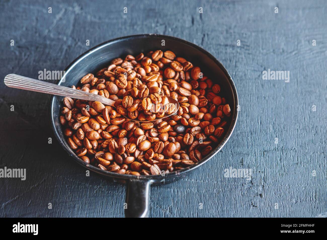 Roasted coffee beans in a pan Stock Photo - Alamy