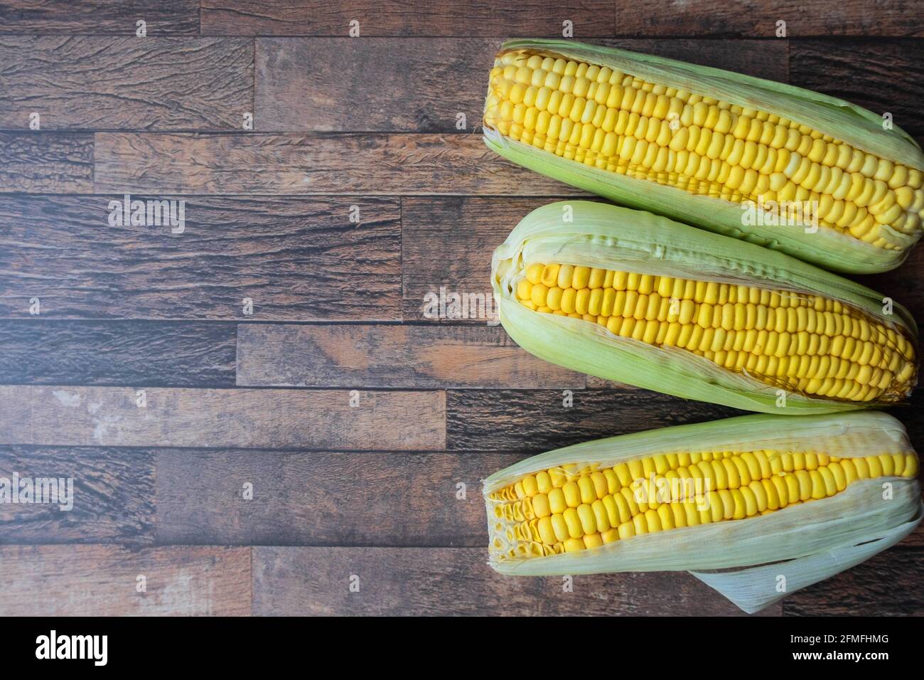 Fresh maize on wooden floor Stock Photo - Alamy
