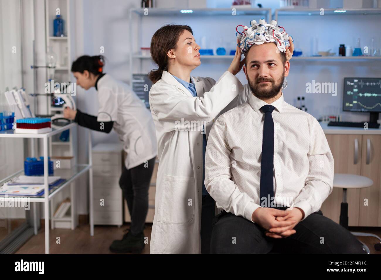 Neurologist doctor analysing brain of man and nervous system using ...