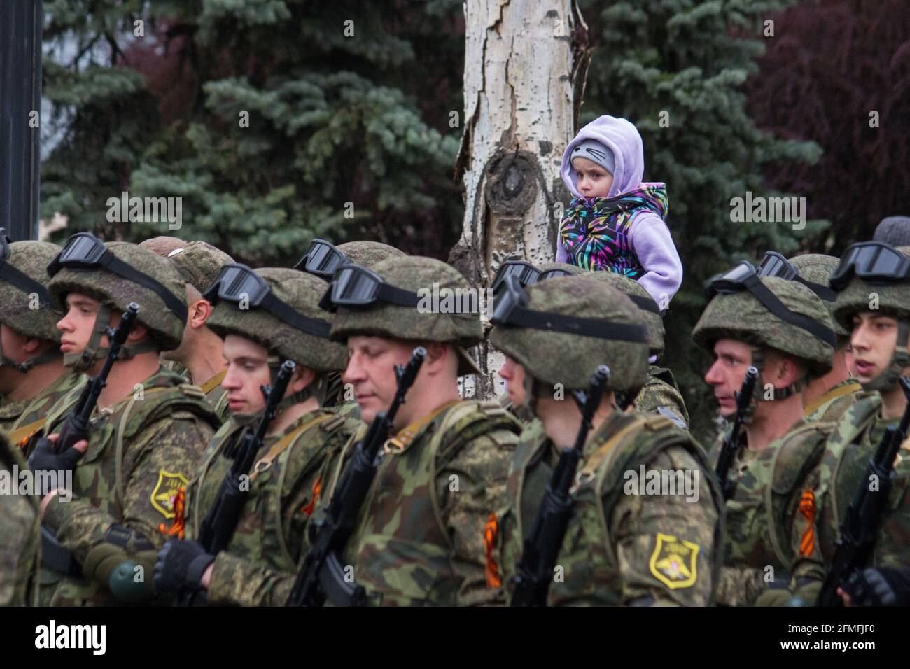 09 May 2021 Donetsk region, Ukraine. A soldier with a small child walks ...