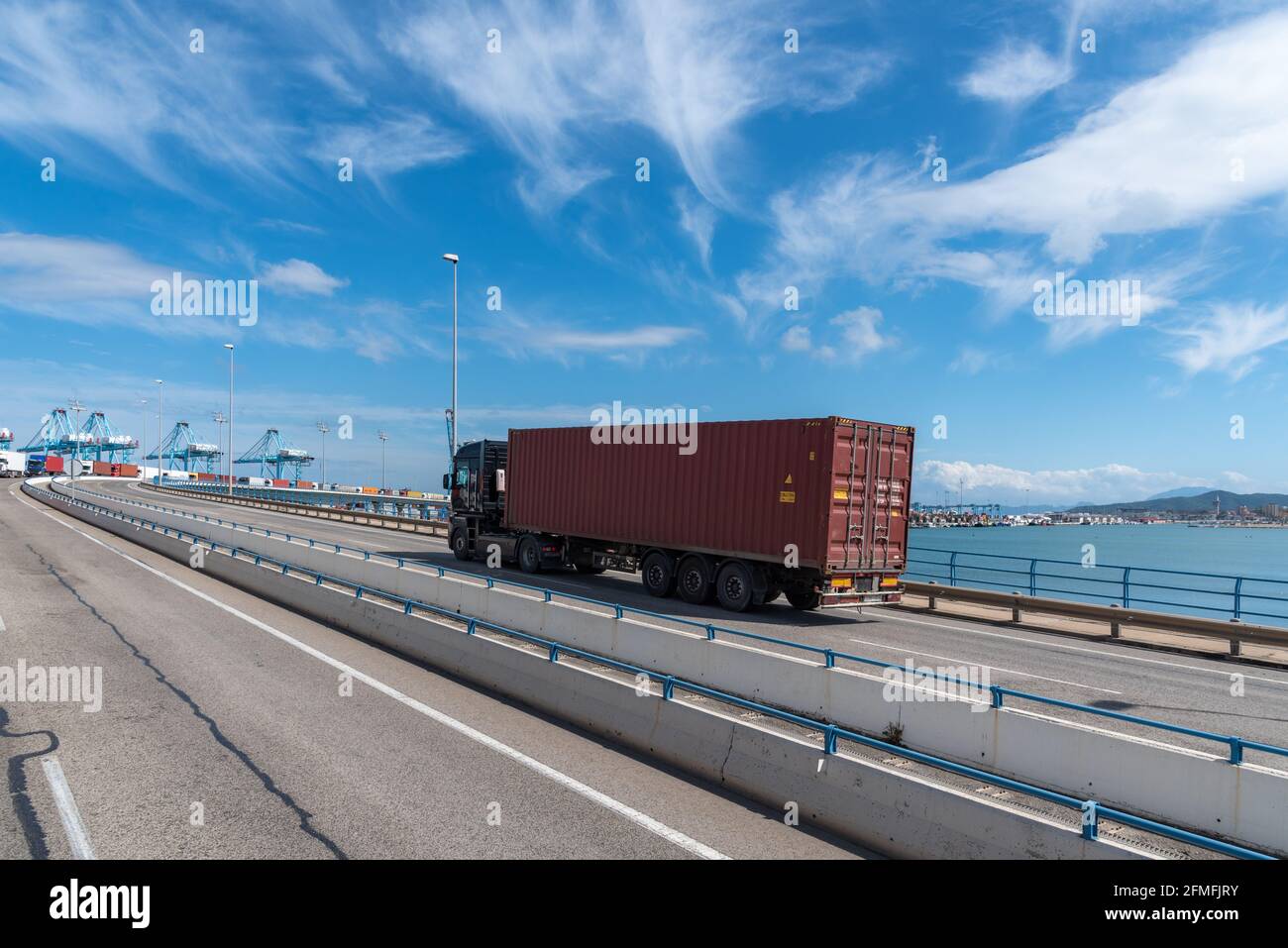 Truck with a container entering the port of Algeciras with a long queue ...