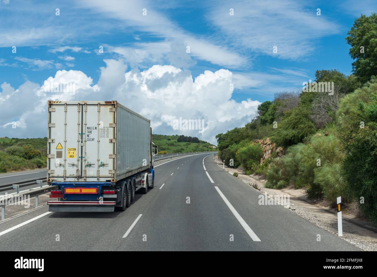 Truck transporting a container circulating on the highway Stock Photo ...