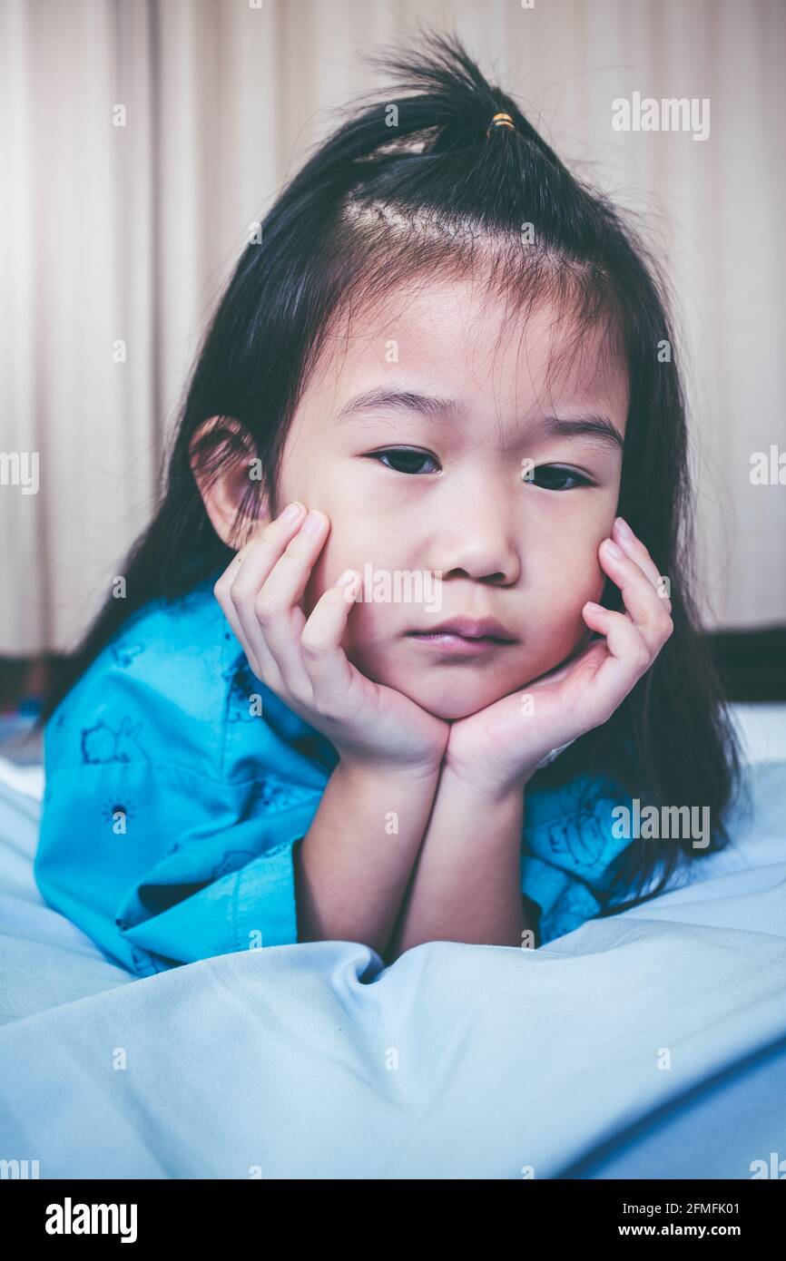 Illness asian child on sickbed and looking away, admitted in hospital ...